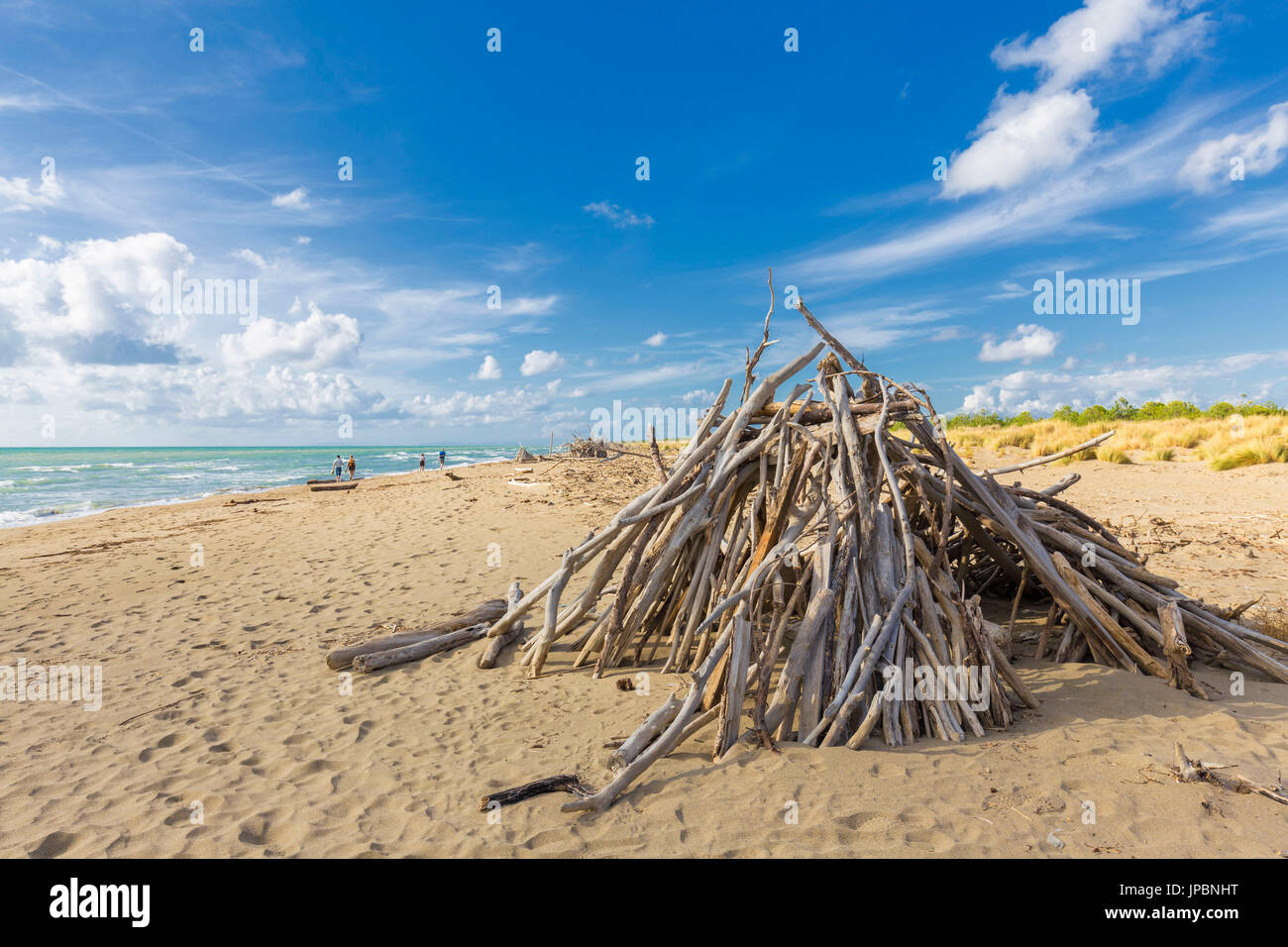 Tourists walk on the beach of Marina di Alberese. Marina di Alberese ...