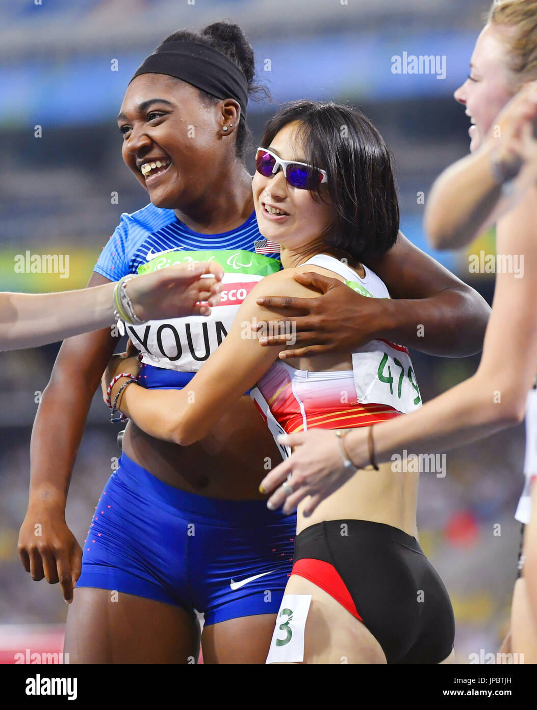 Japan's Sae Tsuji (C) congratulates Deja Young of the United States (L ...