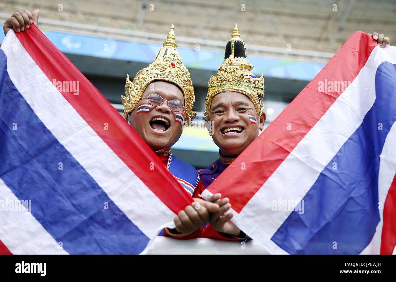 Spectators cheer for Thailand at the athletics venue of the Rio de ...