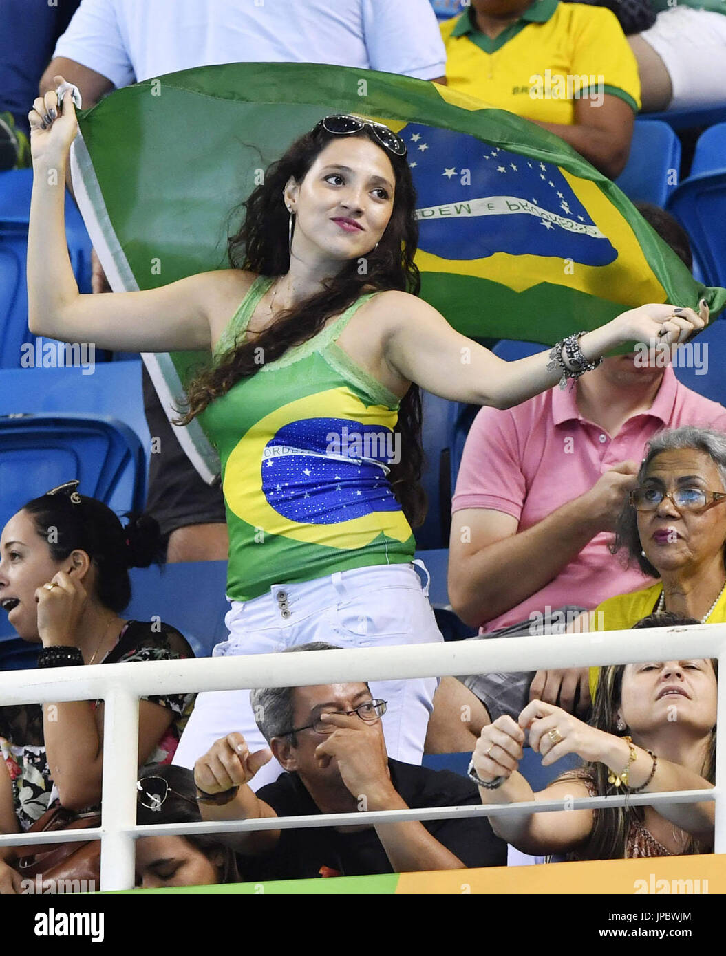 A woman dances as she cheers for host Brazil at the swimming venue of ...