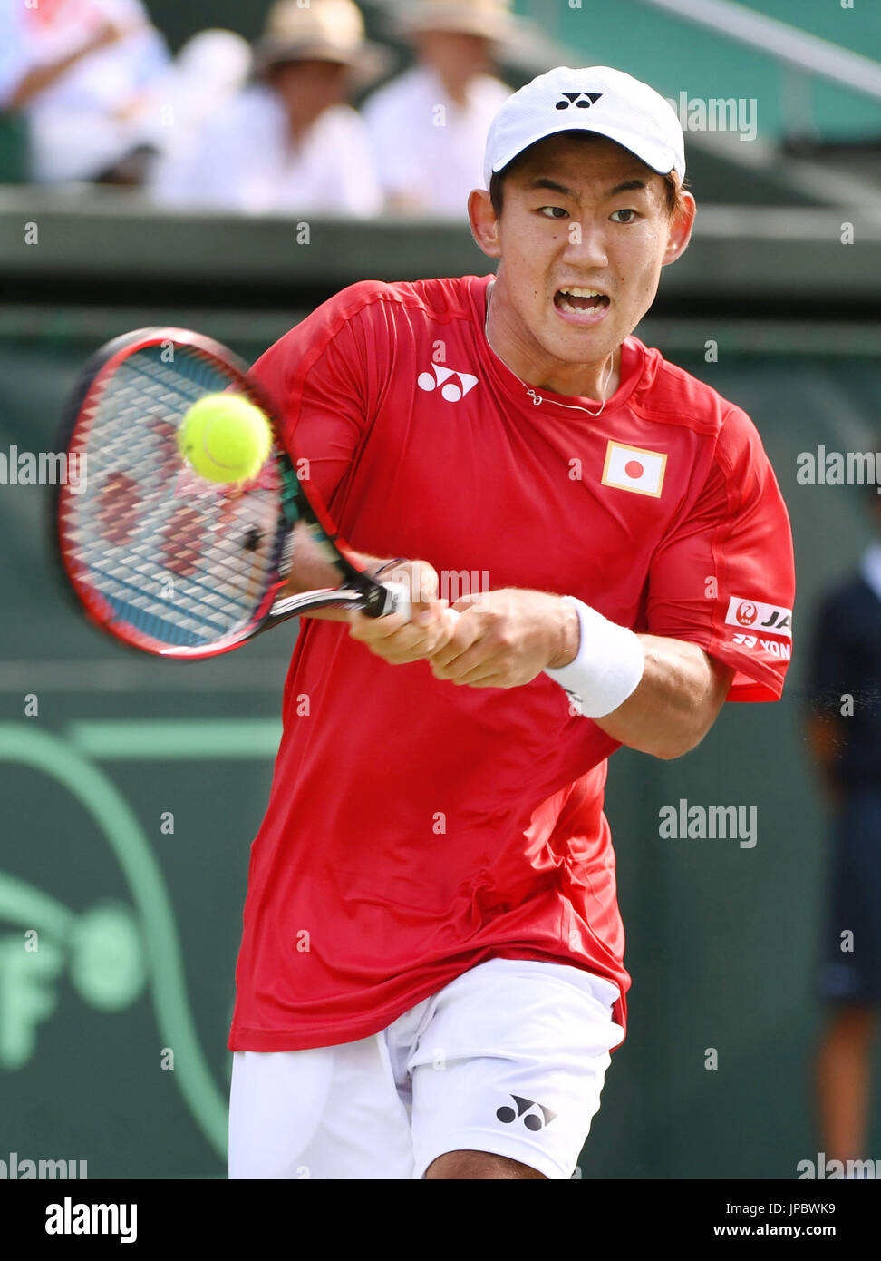 Japan's Yoshihito Nishioka returns a shot against Illya Marchenko of ...