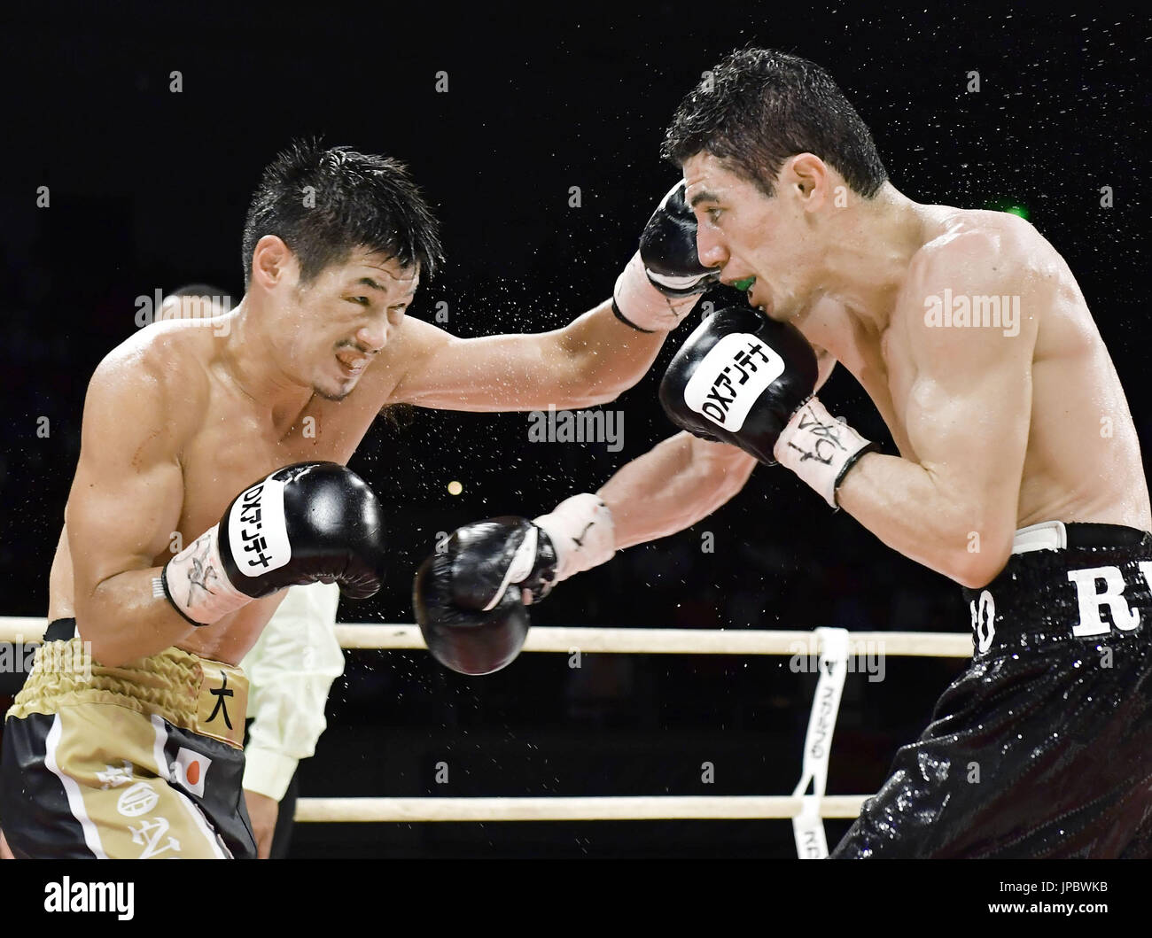Hozumi Hasegawa (L) of Japan throws a punch at Hugo Ruiz of Mexico in ...