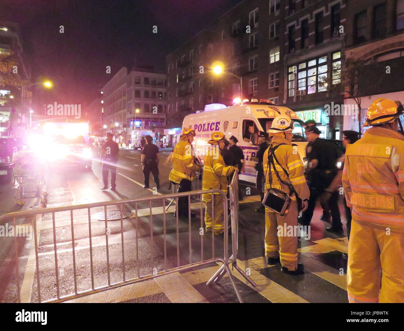 Firefighters and police officers stand guard near the site of an ...