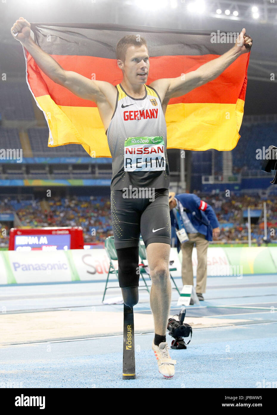 Markus Rehm of Germany celebrates with a national flag after winning ...
