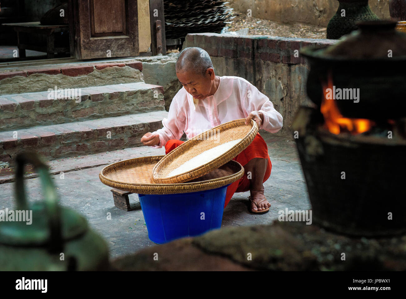South east asia cleaning the rice in a female monastery hi-res stock ...
