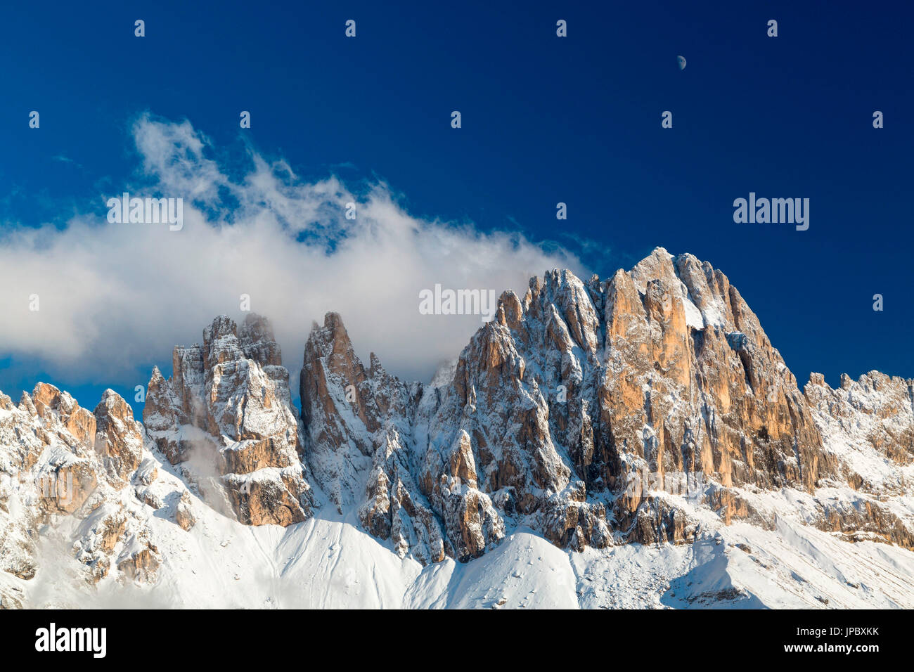 Blue sky and snow on the rocky peaks of the Rosengarten massif in ...