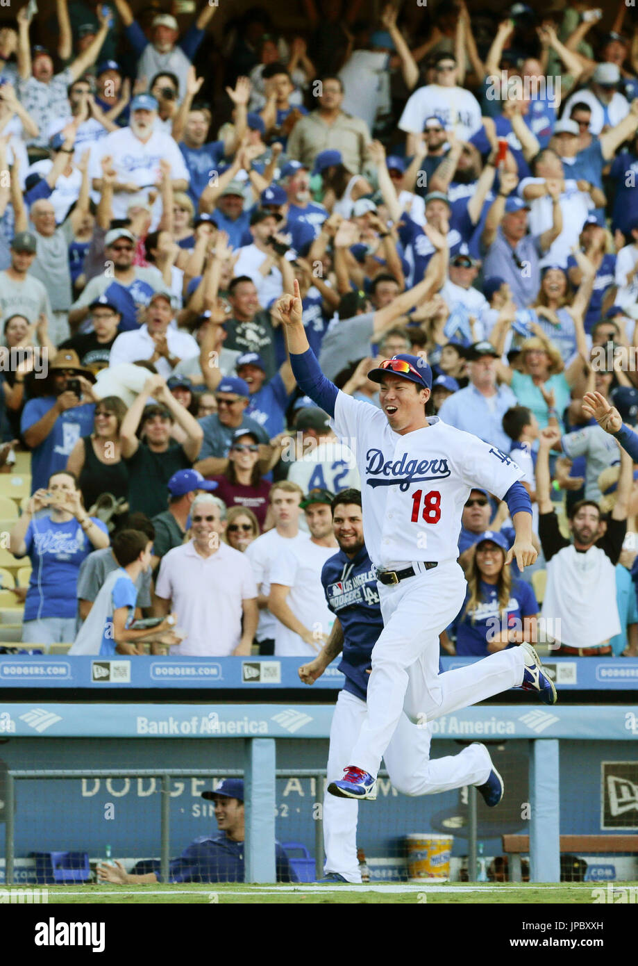 Los Angeles Dodgers pitcher Kenta Maeda dashes out from the dugout ...