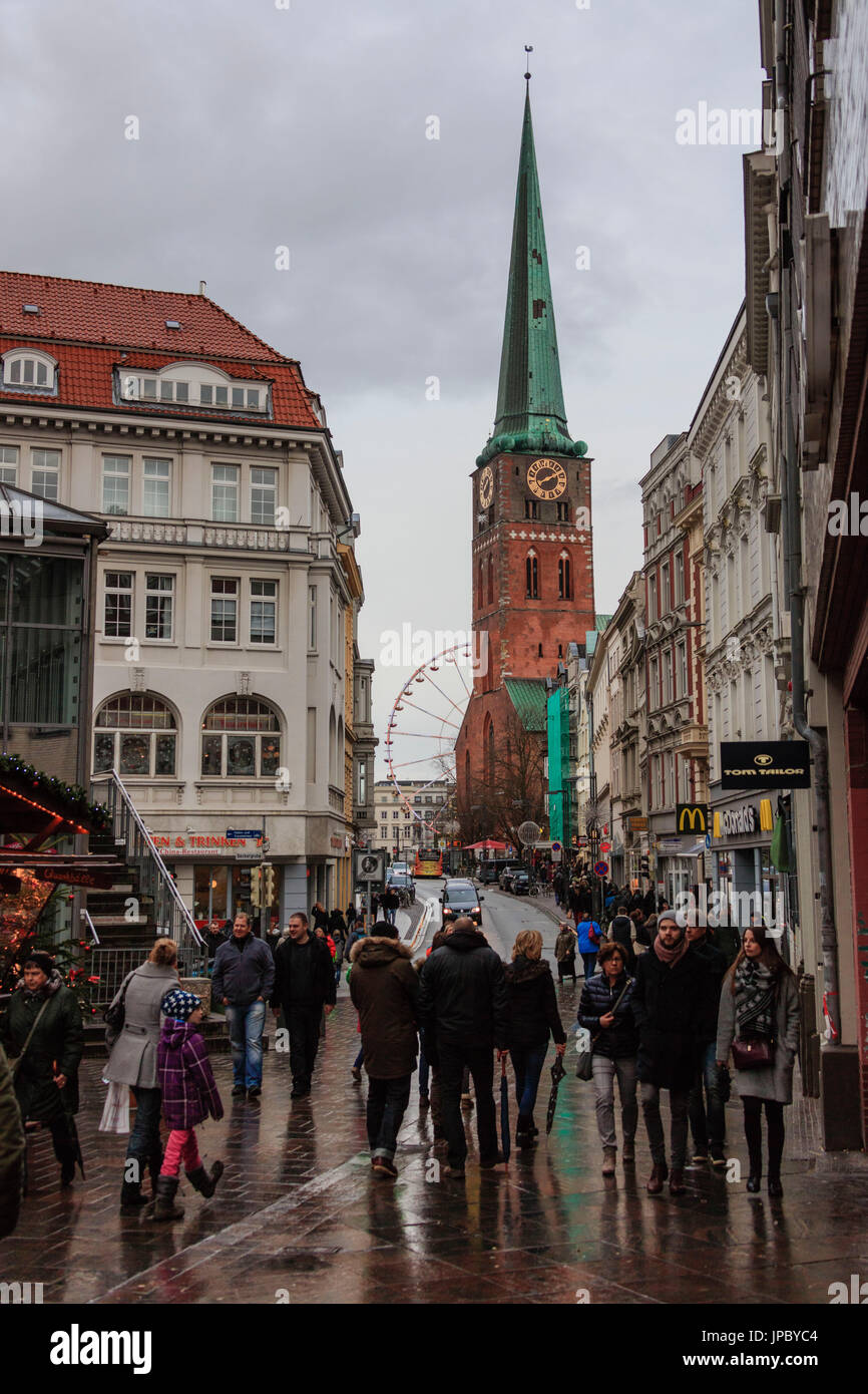 Tourists in the gothic style city center with ancient buildings and ...