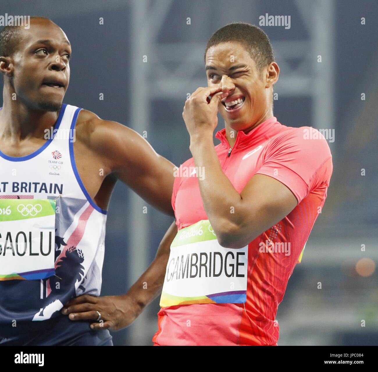 Japan's Asuka Cambridge (R) reacts after running in a men's 100-meter ...