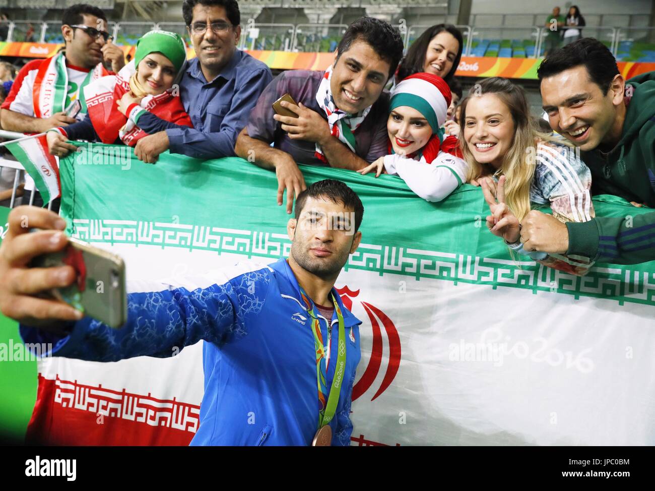 Iranian wrestler Saeid Morad Abdvali takes a photo with supporters ...