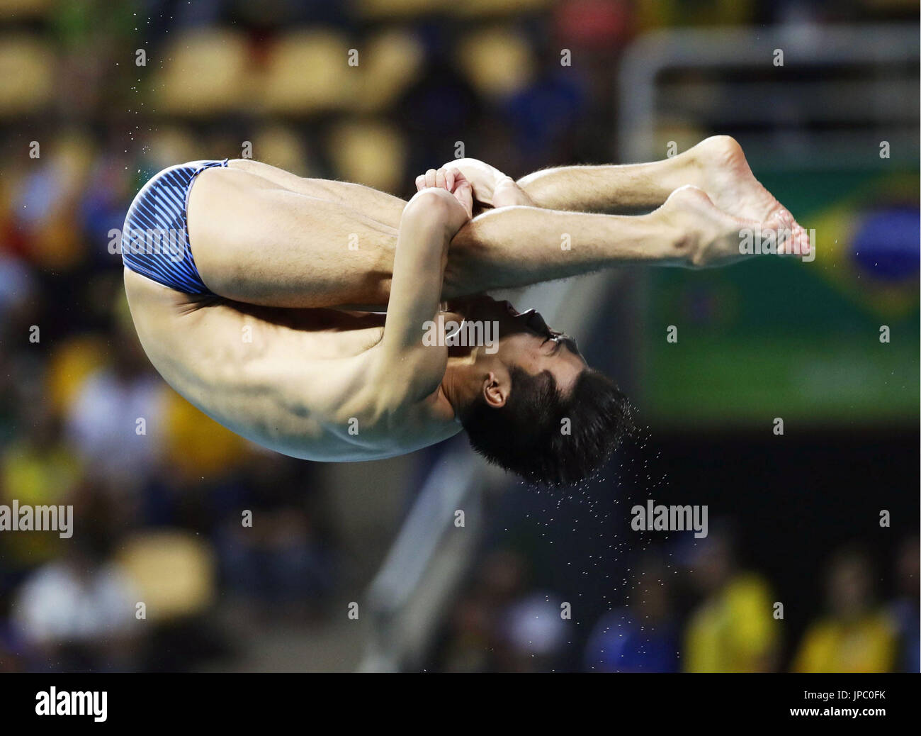 Sho Sakai of Japan performs in the men's 3-meter springboard diving ...