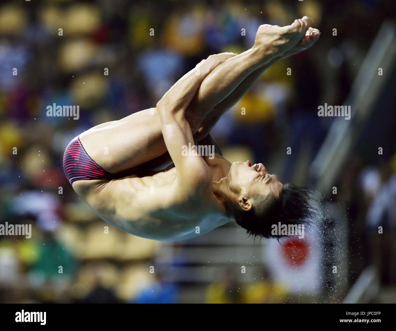 Ken Terauchi of Japan performs in the men's 3-meter springboard diving ...