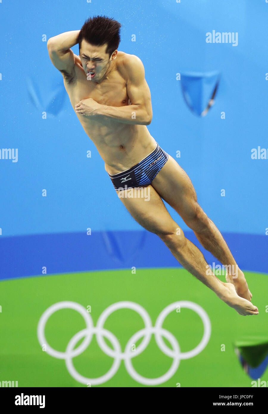 Sho Sakai of Japan performs in the men's 3-meter springboard diving ...