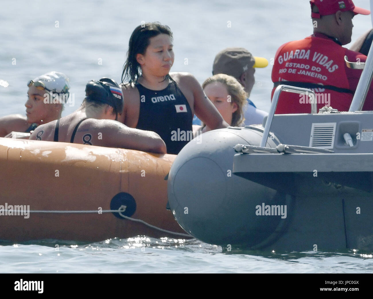Yumi Kida (C) of Japan rests with other swimmers after finishing the 10 ...