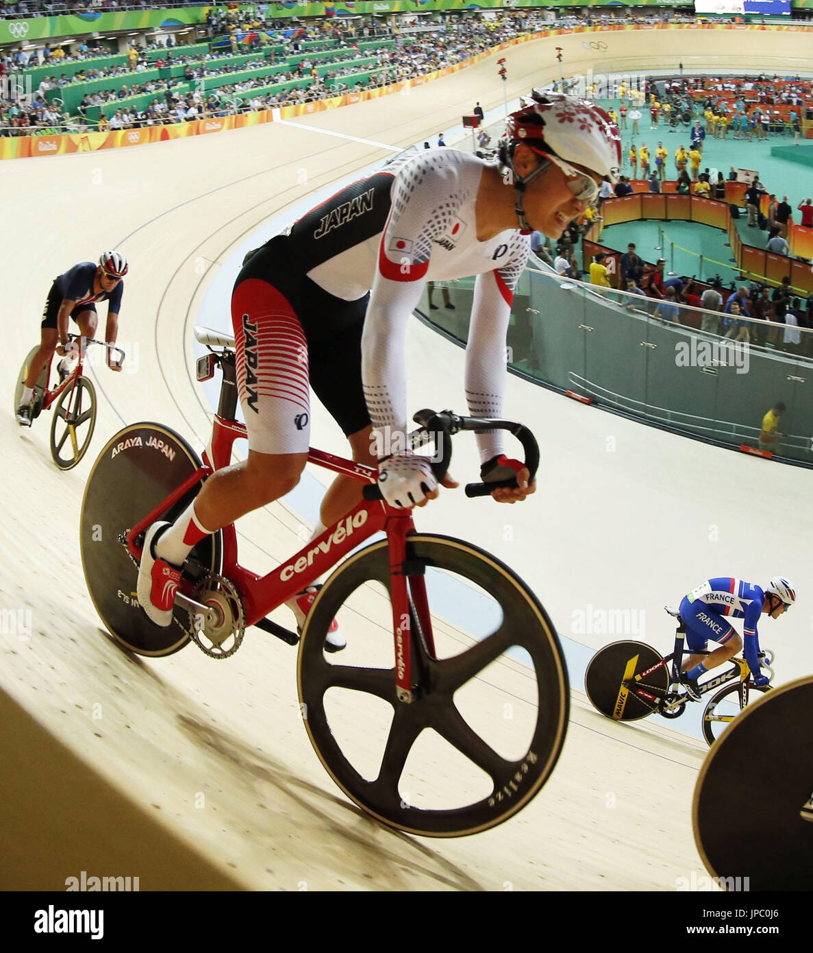Japanese cyclist Kazushige Kuboki (C) competes in the men's omnium ...