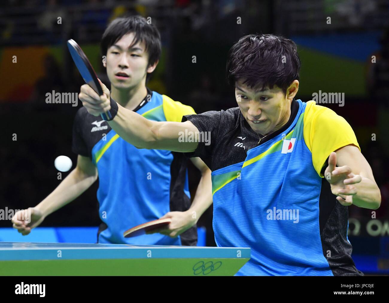 Japan's Koki Niwa (L) and Maharu Yoshimura play against Bastian Steger ...
