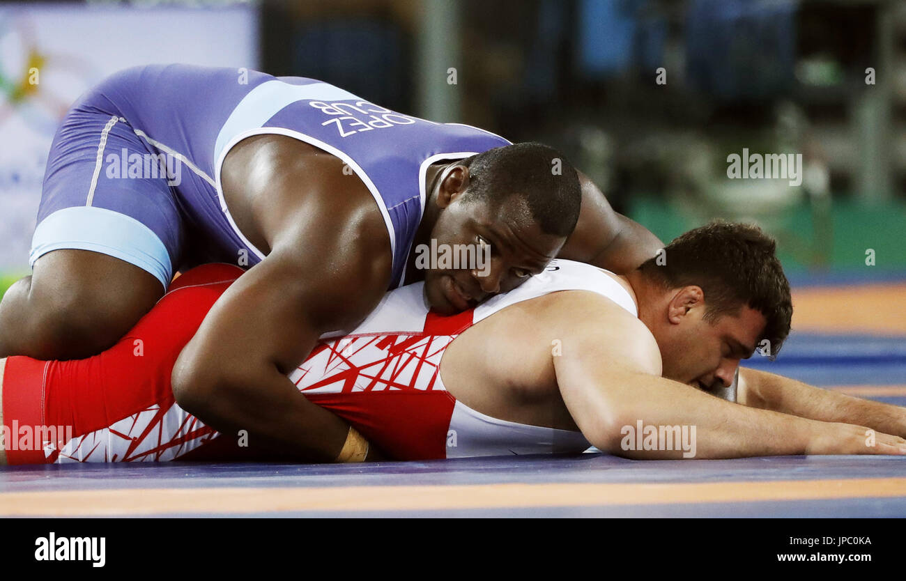 Cuban wrestler Mijain Lopez (top) and Riza Kayaalp of Turkey compete in ...