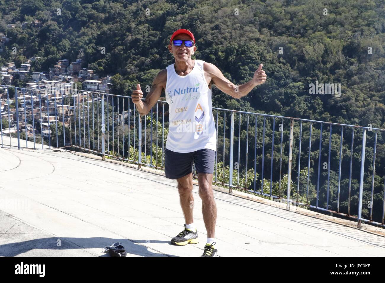 Rio Olympics torch relay runner Albino Roca, 69, poses on top of Morro ...