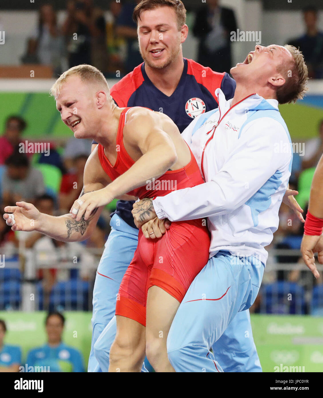 The coach of Norwegian wrestler Stig-Andre Berge is ecstatic after the ...