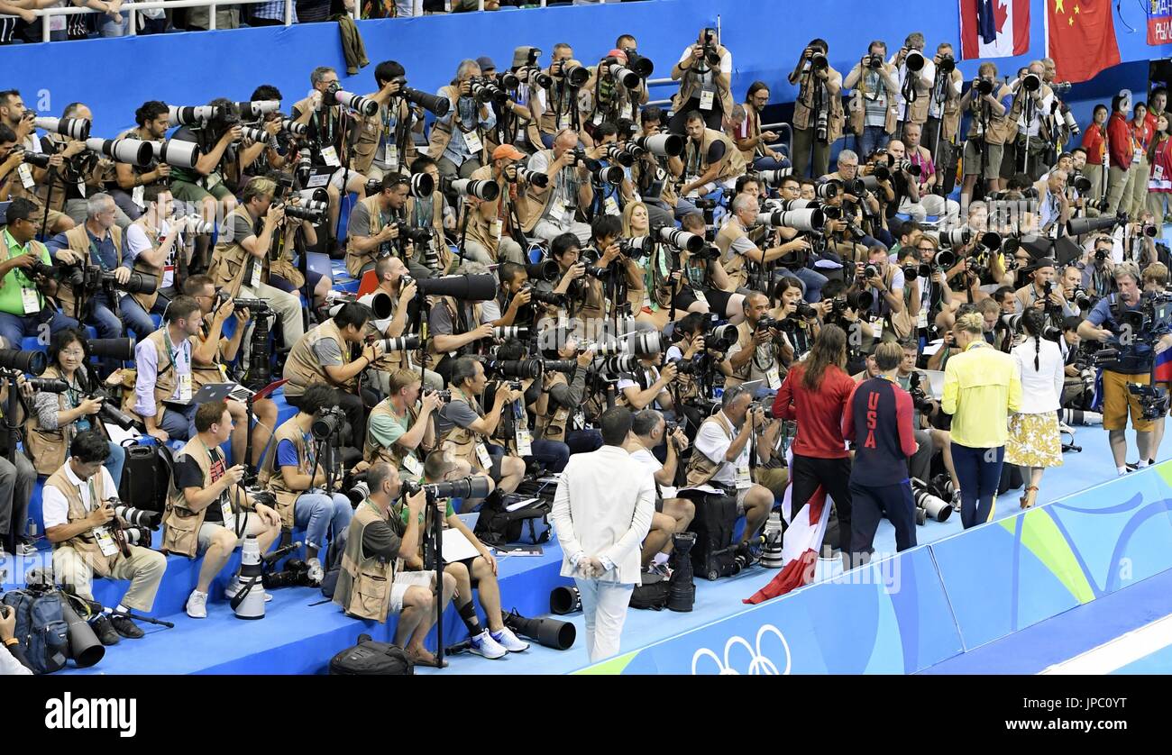 Photographers crowd the medal ceremony for the women's swimming 100 ...