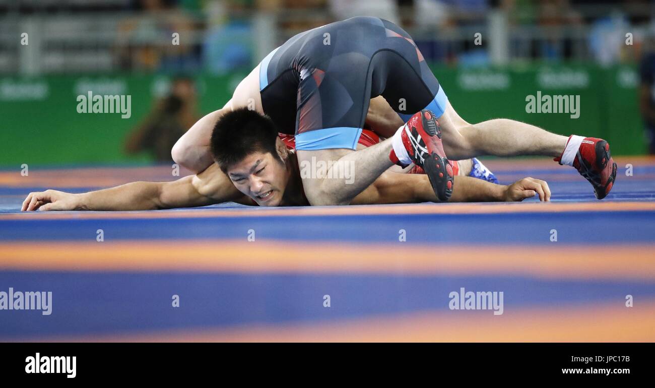 Japanese wrestler Tomohiro Inoue (bottom) and Shmagi Bolkvadze of Georgia compete during a men's ...