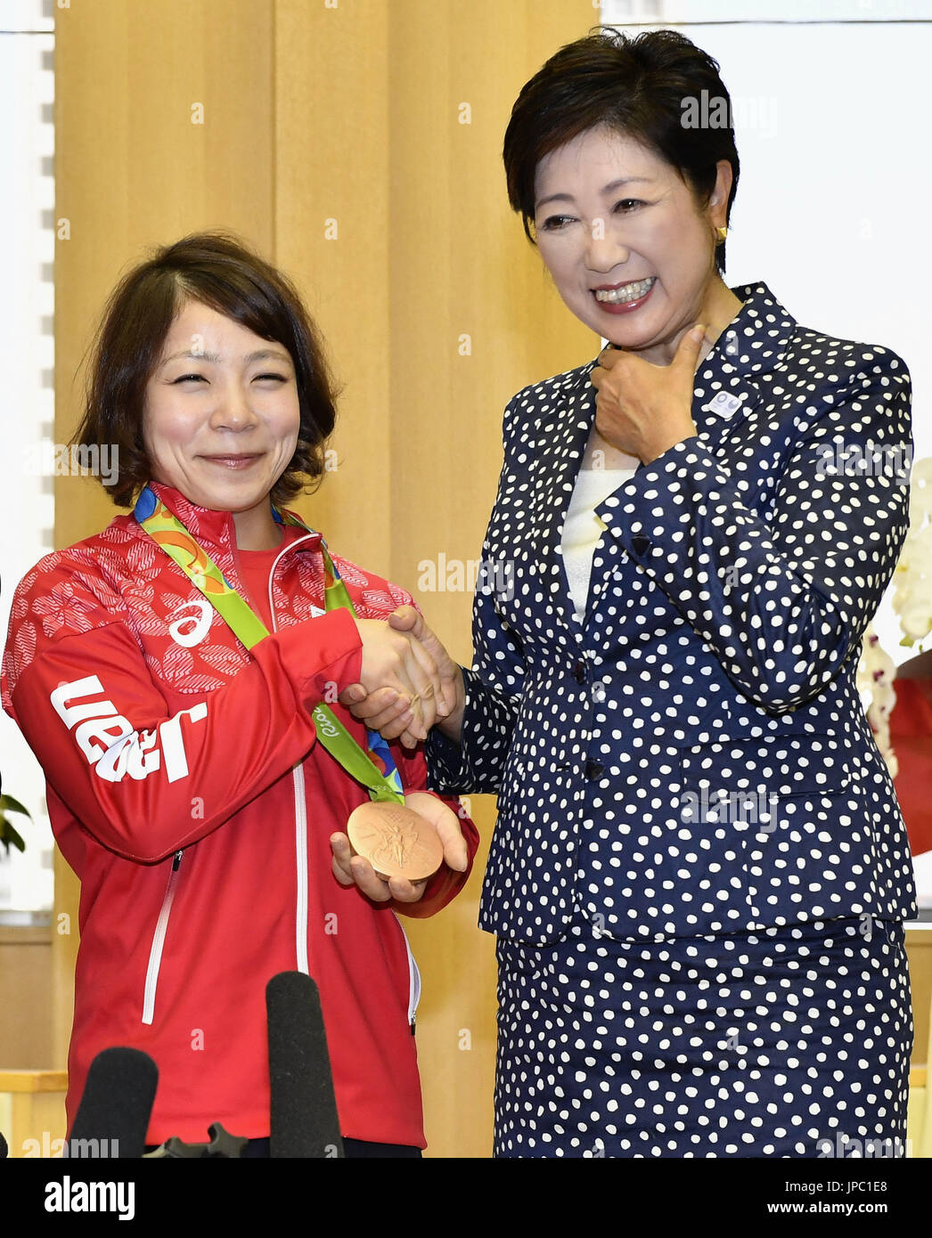 Japanese weightlifter Hiromi Miyake (L) shake hands with Tokyo Gov ...