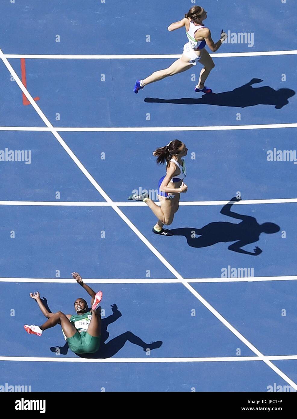 South African sprinter Tsholofelo Thipe tumbles after crossing the ...