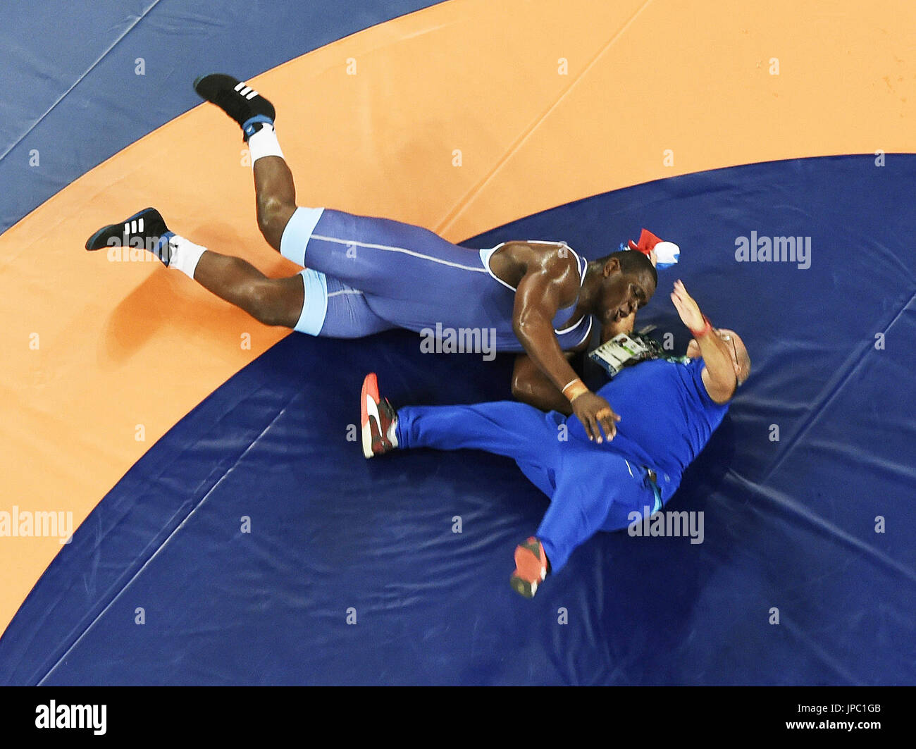 Cuban wrestler Mijian Lopez throws his coach in celebration after ...