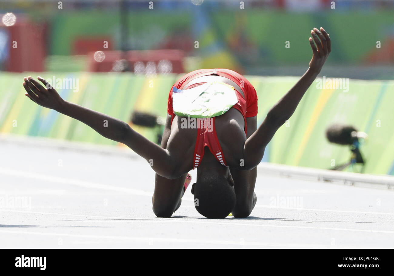 Bahrain's Ruth Jebet puts her head on the track after winning the women ...