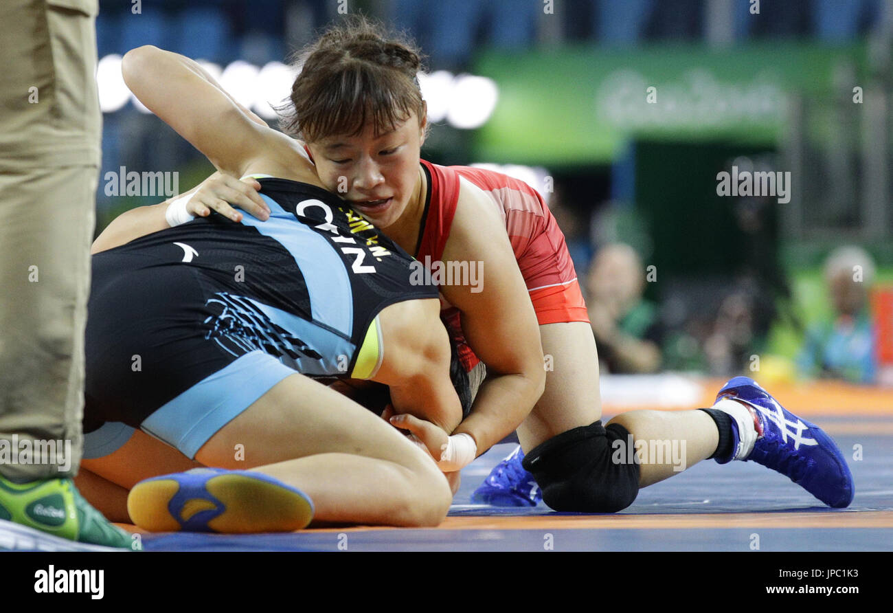 Japan's Eri Tosaka (R) faces off against China's Sun Yanan during a ...