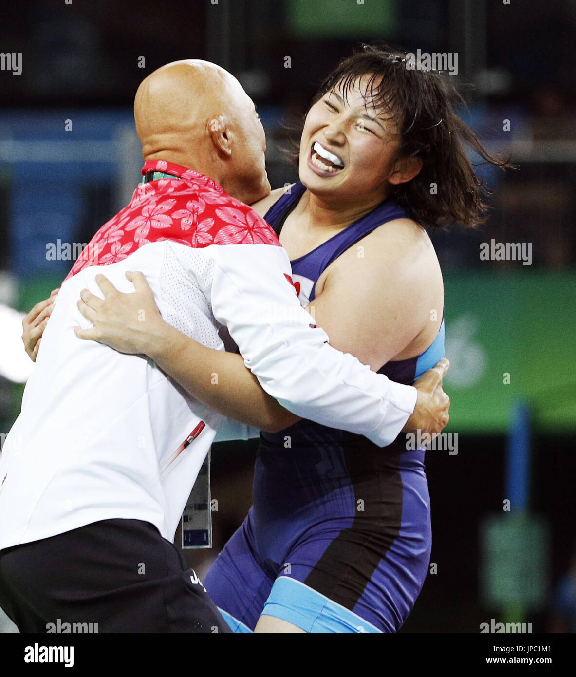 Japanese wrestler Sara Dosho (R) celebrates with team director Kazuhito ...