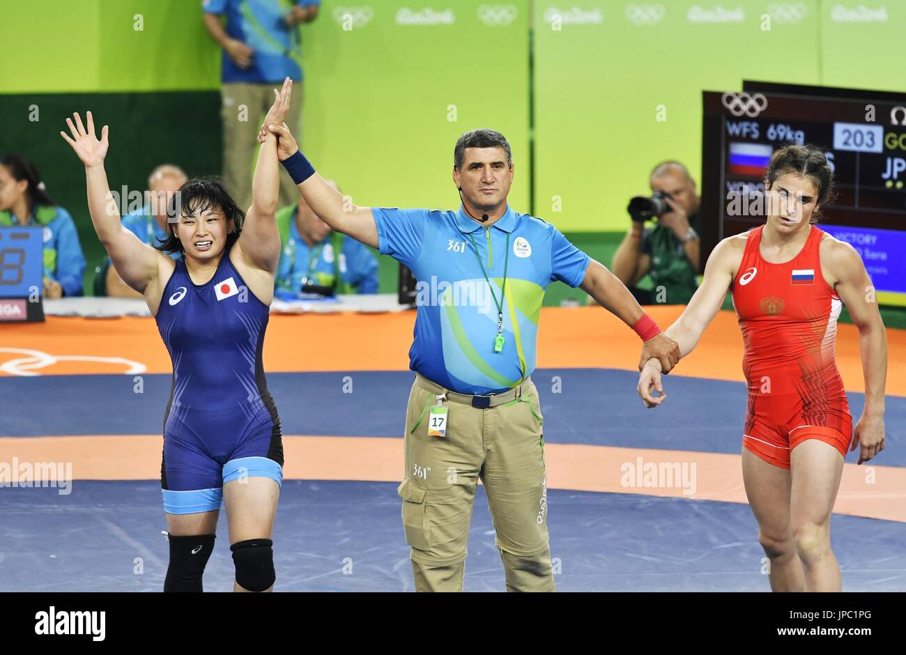 Japanese wrestler Sara Dosho (L) is declared the winner over Russia's ...