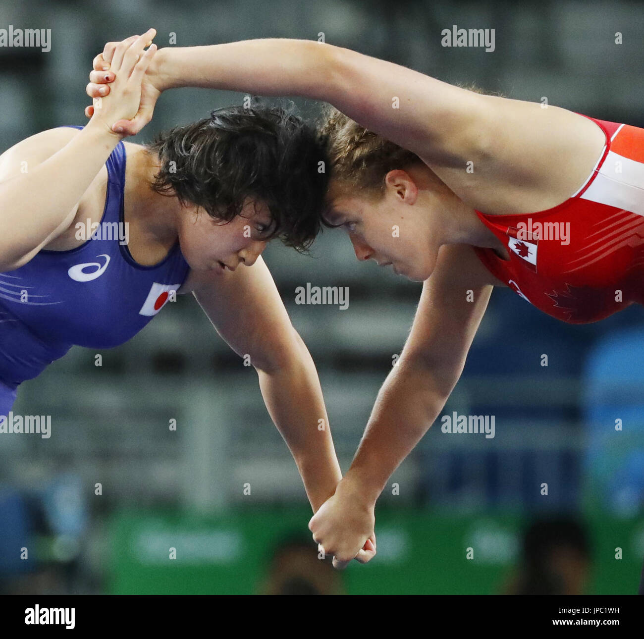 Japanese wrestler Sara Dosho (L) competes against Canada's Dorothy ...