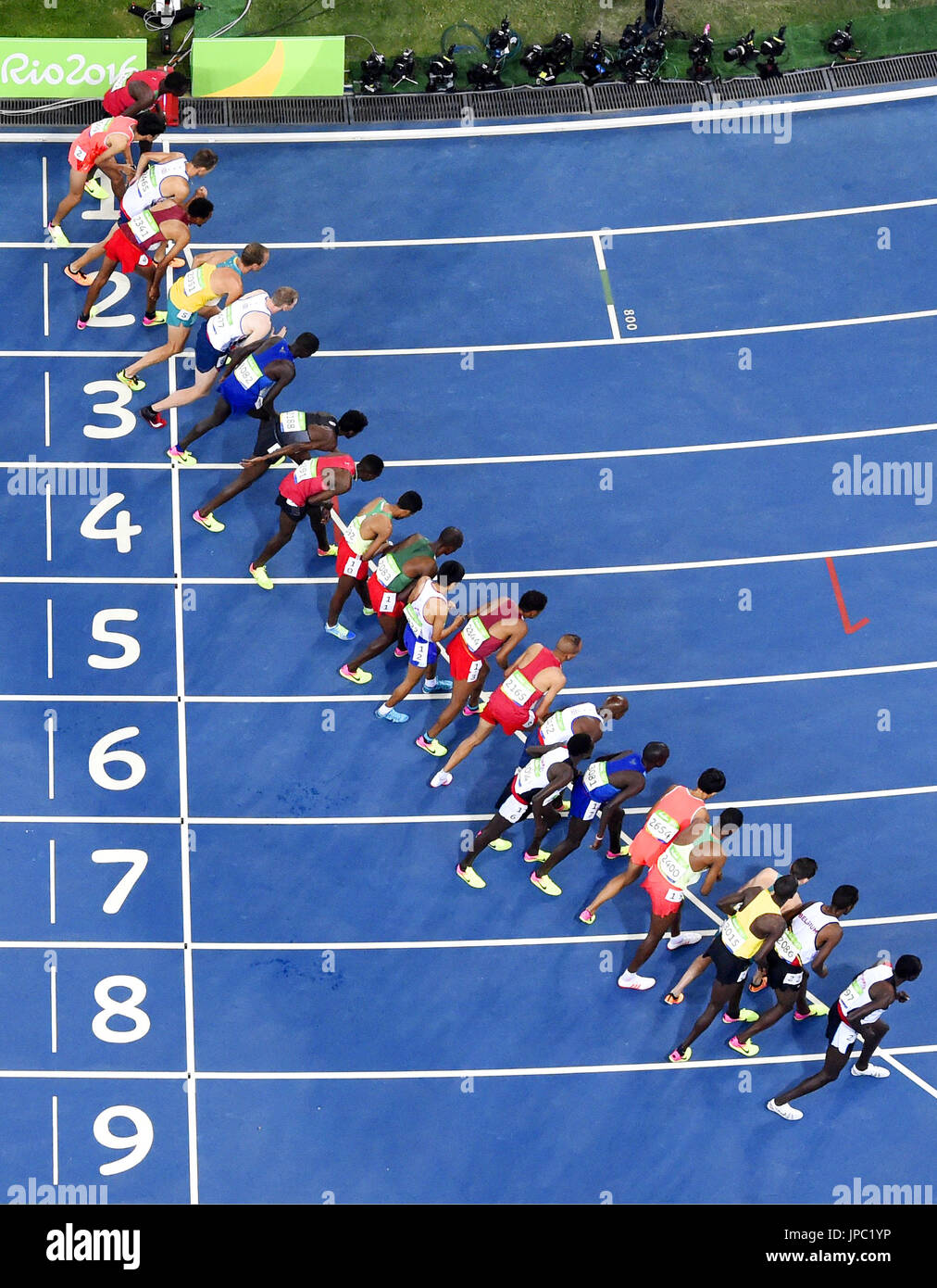Photo taken from a ceiling camera shows runners set at a slanted start ...