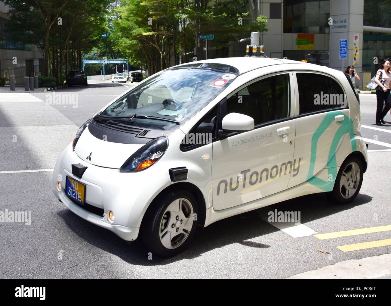 An autonomous taxi turns at an intersection during a test drive in ...