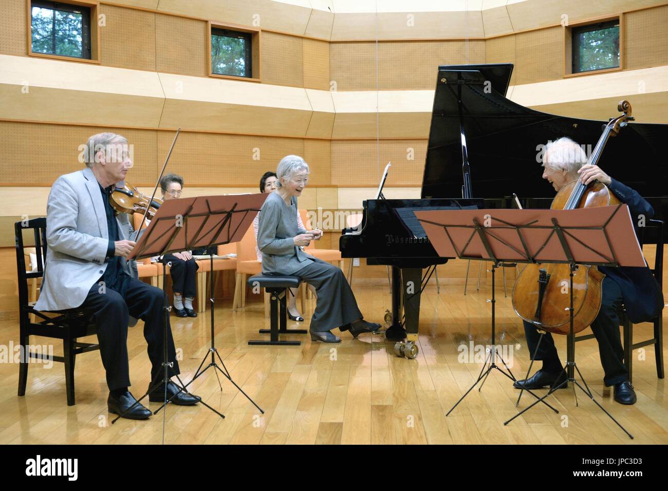 Japanese Empress Michiko (C) looks to Wolfgang Boettcher (R), former ...