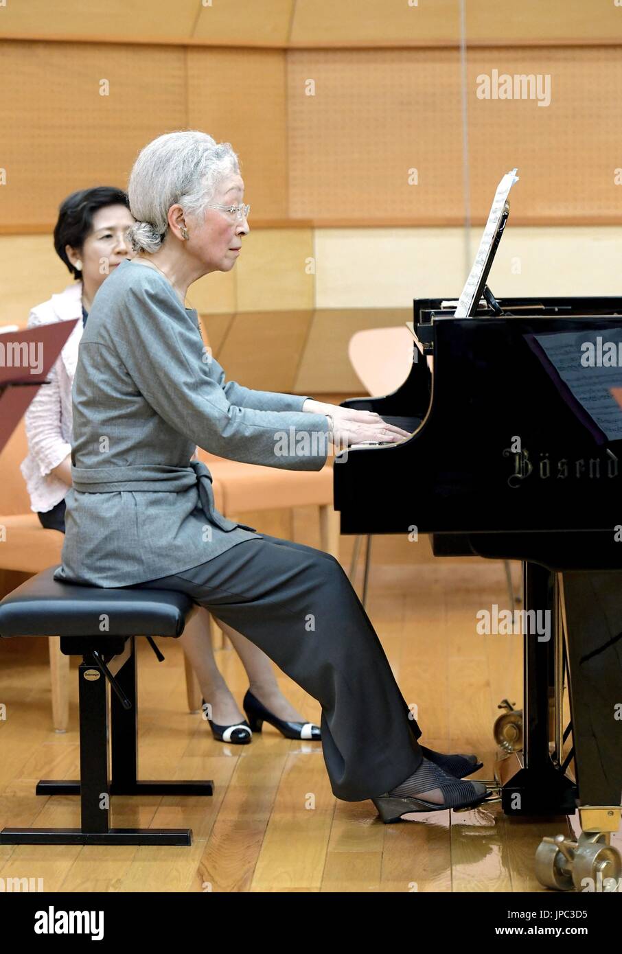 Japanese Empress Michiko plays the piano during a workshop with foreign ...
