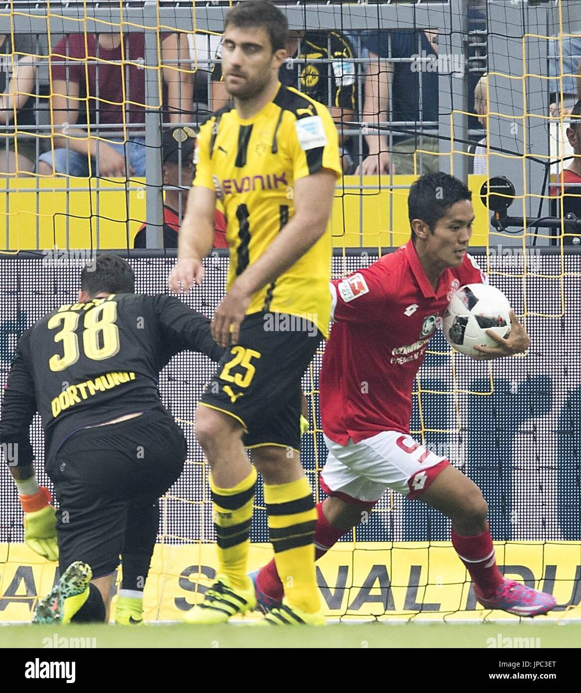 Yoshinori Muto (R) of Mainz brings the ball back to midfield after ...