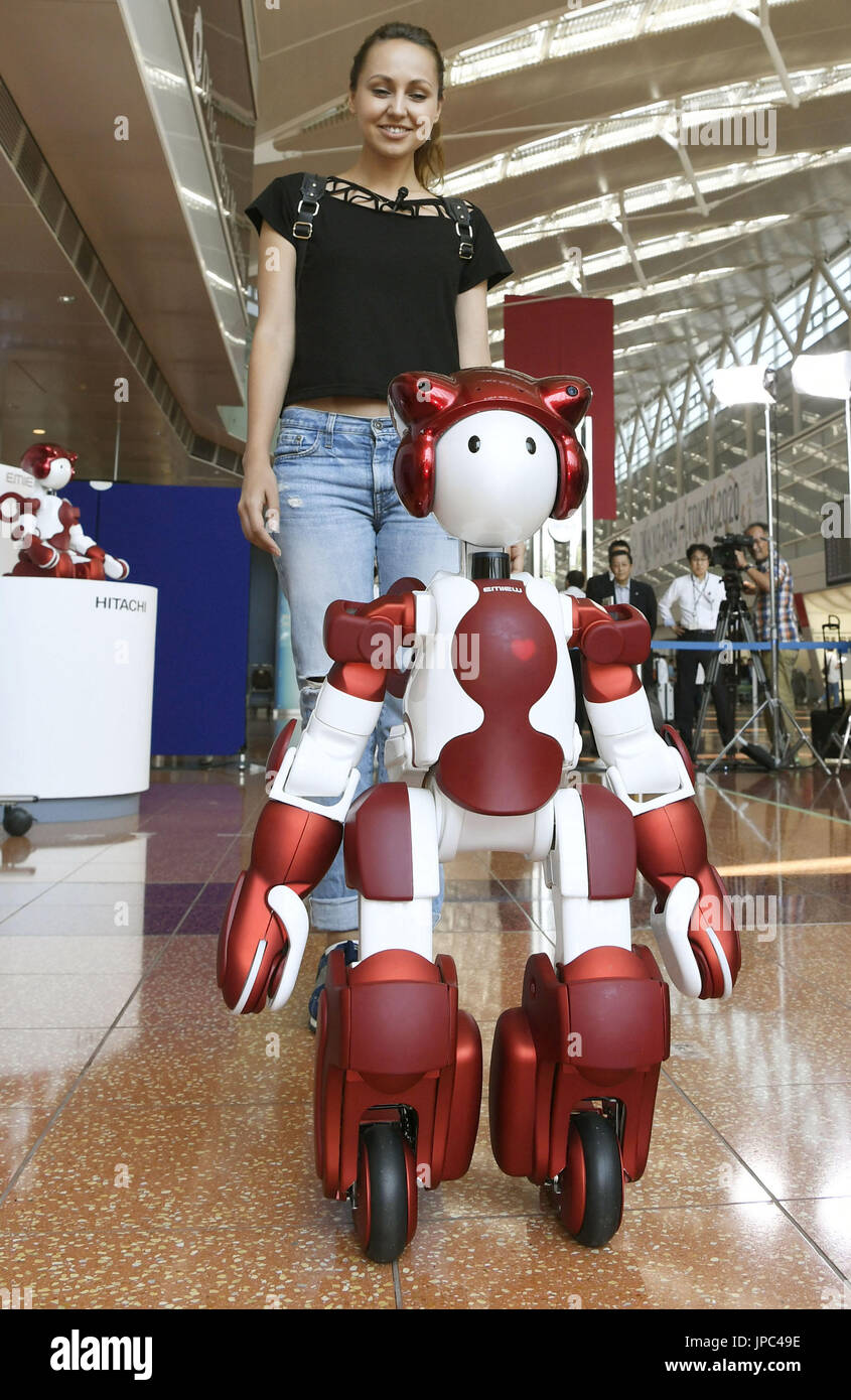 Developed by Hitachi Ltd., humanoid robot EMIEW3 guides a woman, who ...