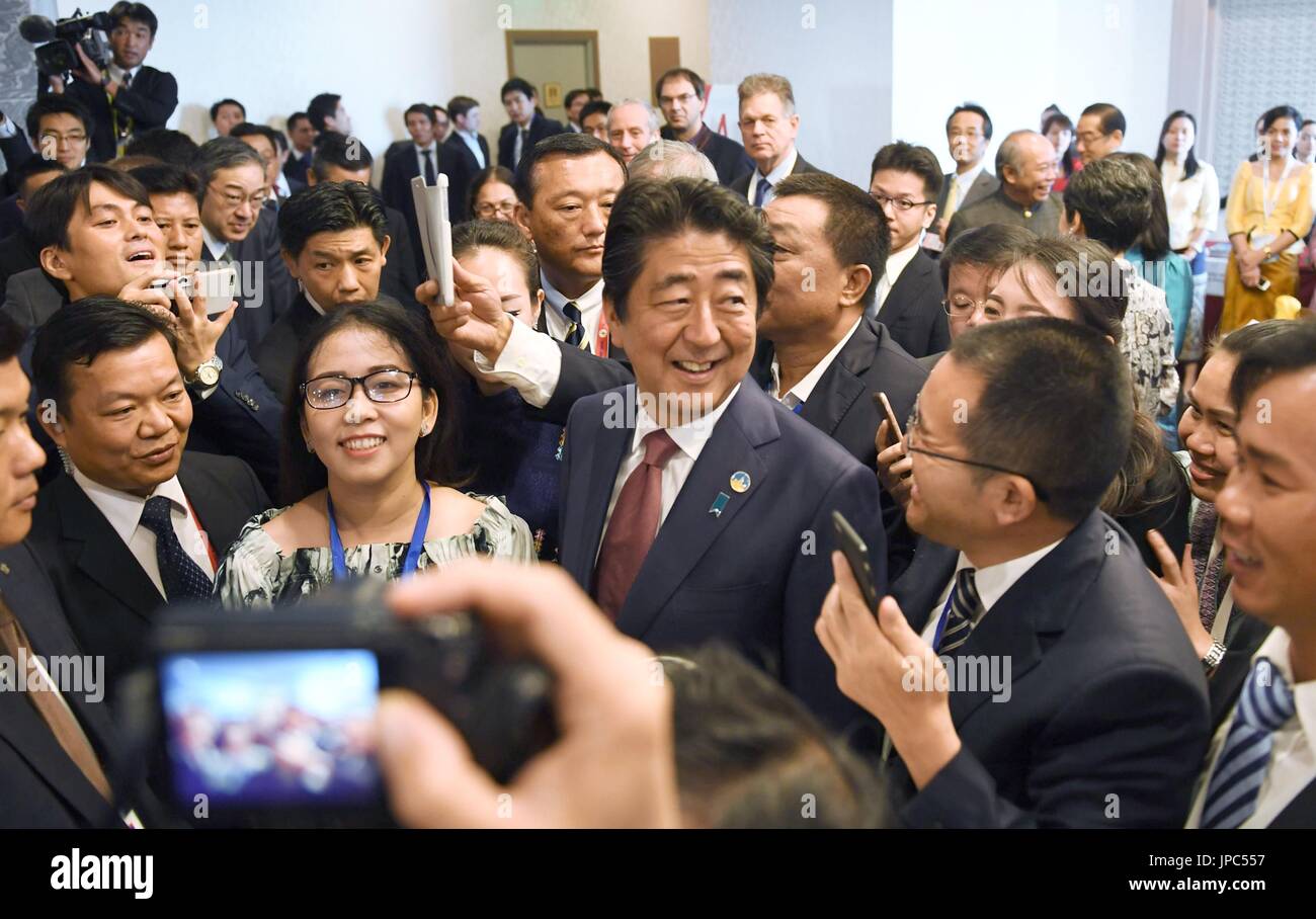 Japan's Prime Minister Shinzo Abe (C) is asked to pose for photos after ...