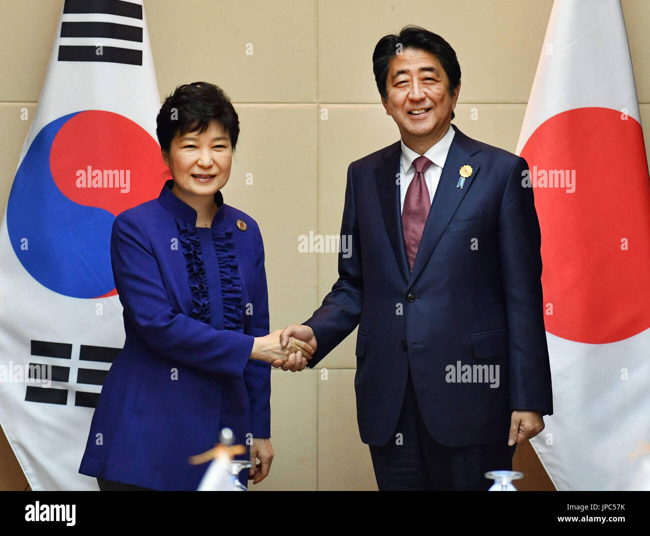 Japanese Prime Minister Shinzo Abe (R) and South Korean President Park ...