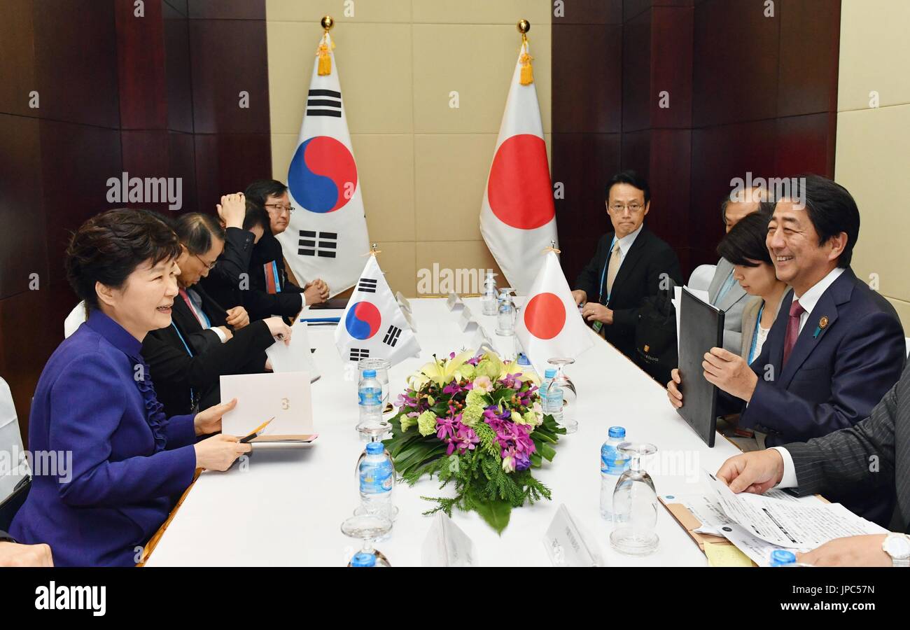 Japanese Prime Minister Shinzo Abe (front R) and South Korean President ...