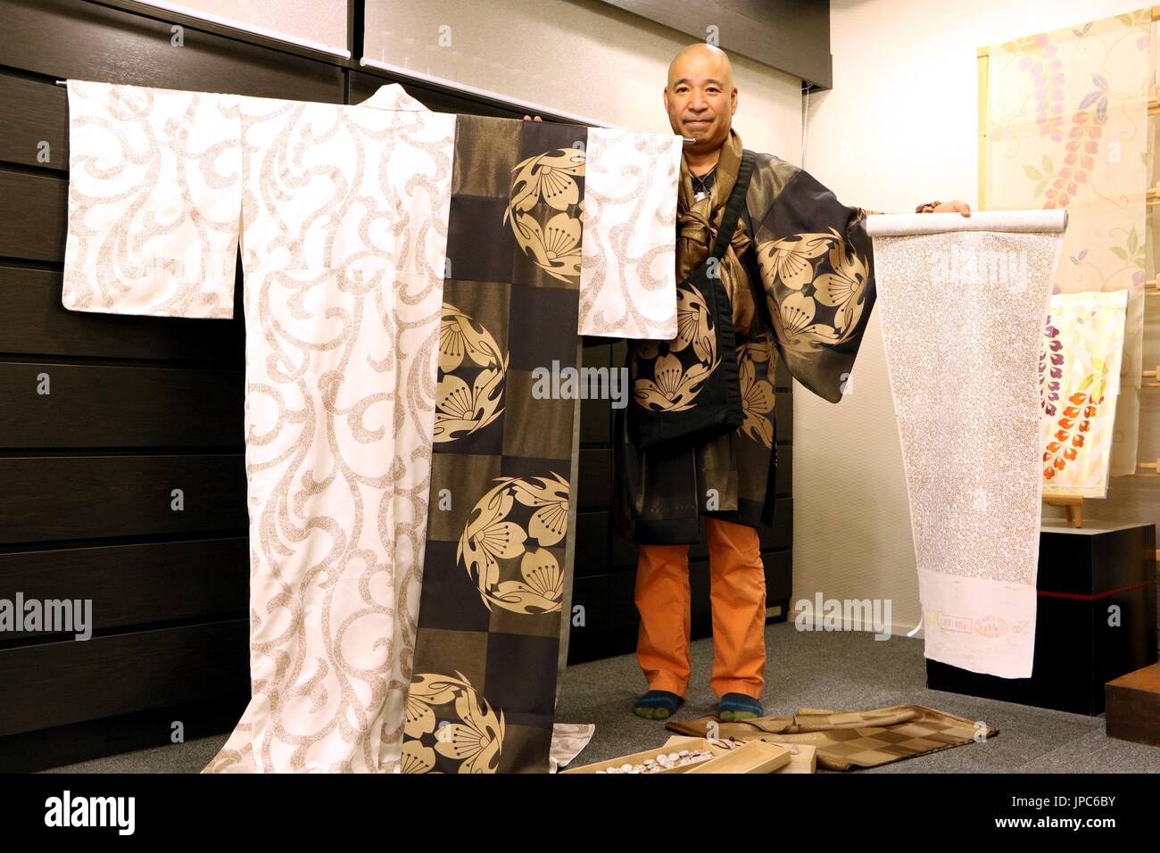 Kimono designer Nobuaki Tomita poses with a kimono and obi sash made of ...