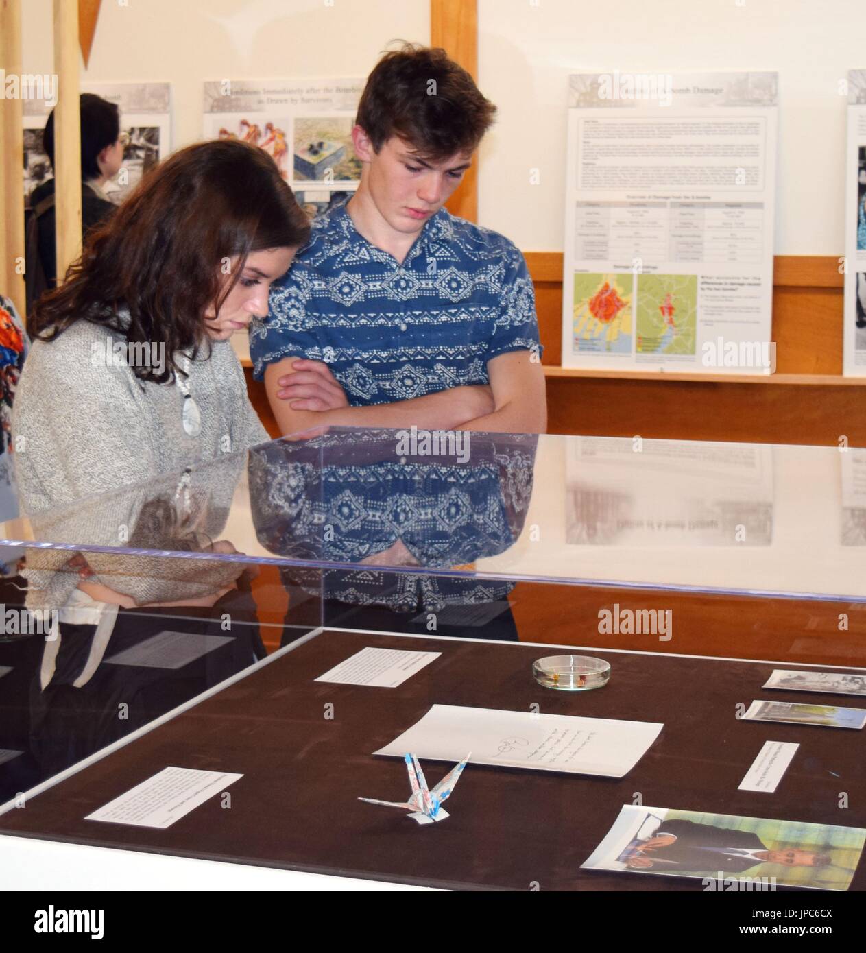 Visitors look at a paper crane folded by U.S. President Barack Obama ...