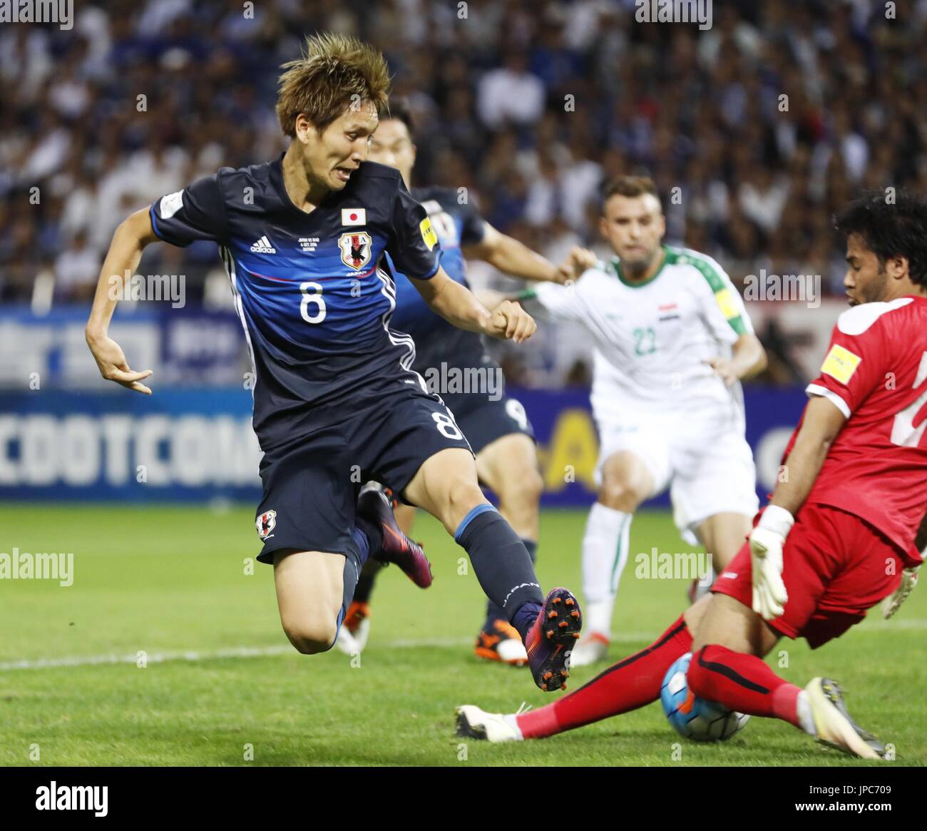 Genki Haraguchi of Japan (L) scores the opening goal during the first ...