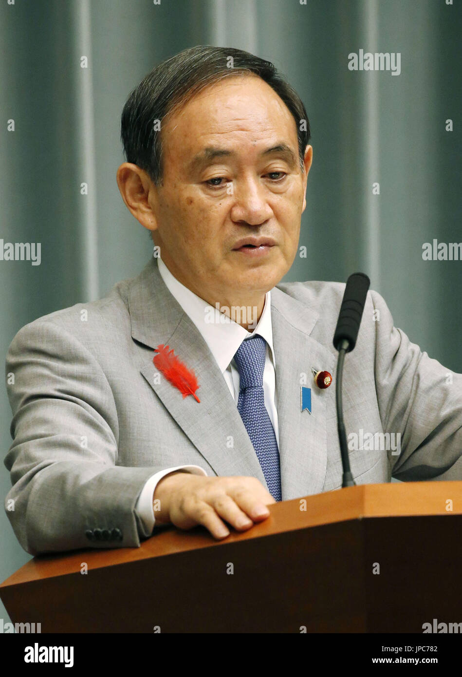 Japanese Chief Cabinet Secretary Yoshihide Suga tells a press ...