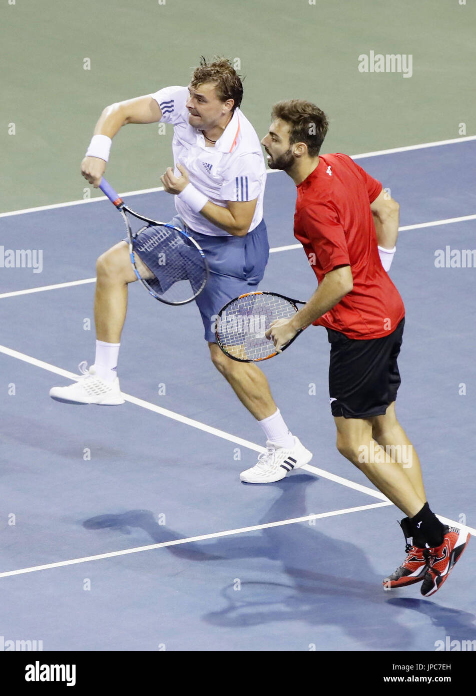Marcin Matkowski of Poland (L) returns the ball as teammate Marcel ...