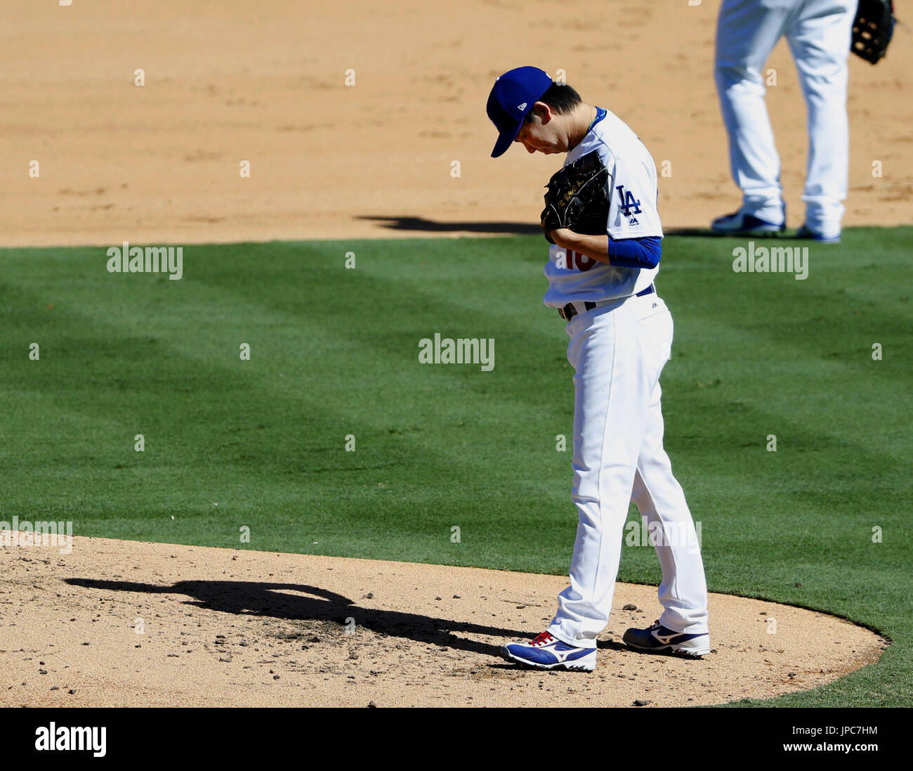 Los Angeles Dodgers pitcher Kenta Maeda looks downcast after allowing a ...