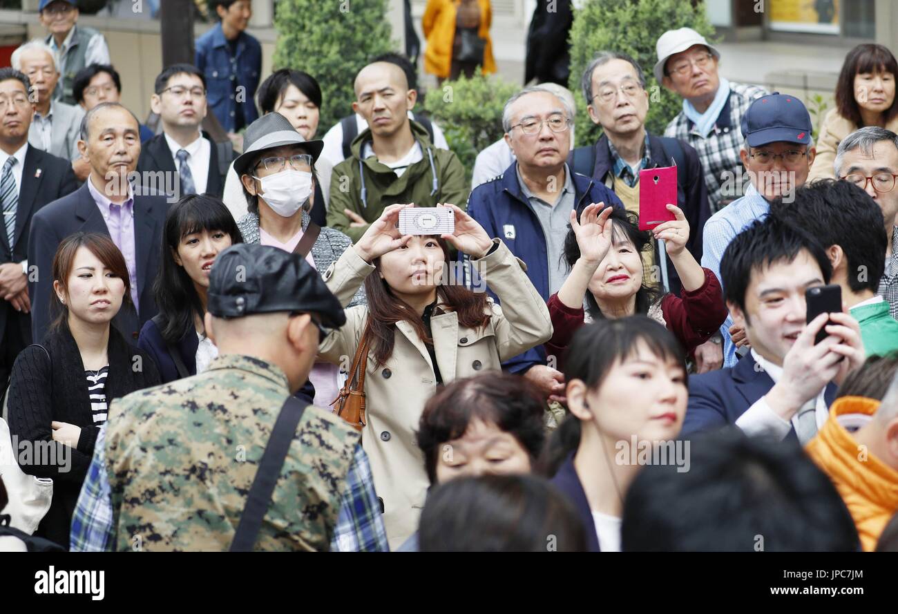 People listen to a stump speech by a candidate running in a lower house ...