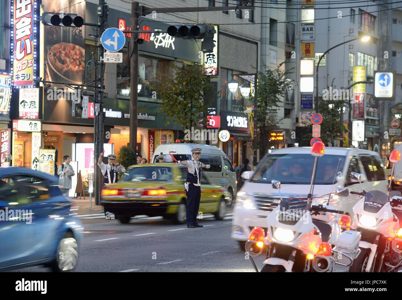 Police officers direct traffic in Tokyo on Oct. 12, 2016, after traffic ...